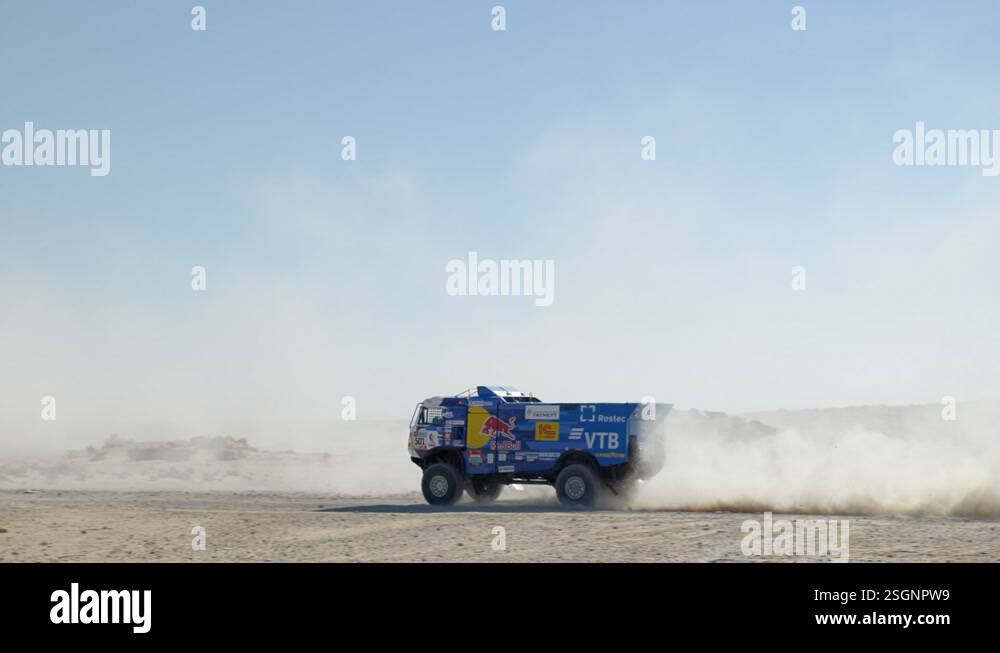 Big Dakar Rally truck driving past with clouds of dusty golden sand on ...