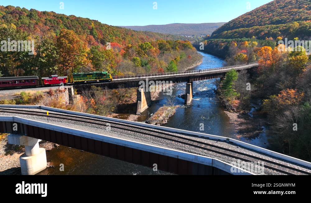 Scenic railroad ride in Pennsylvania. Aerial of locomotive, red caboose ...