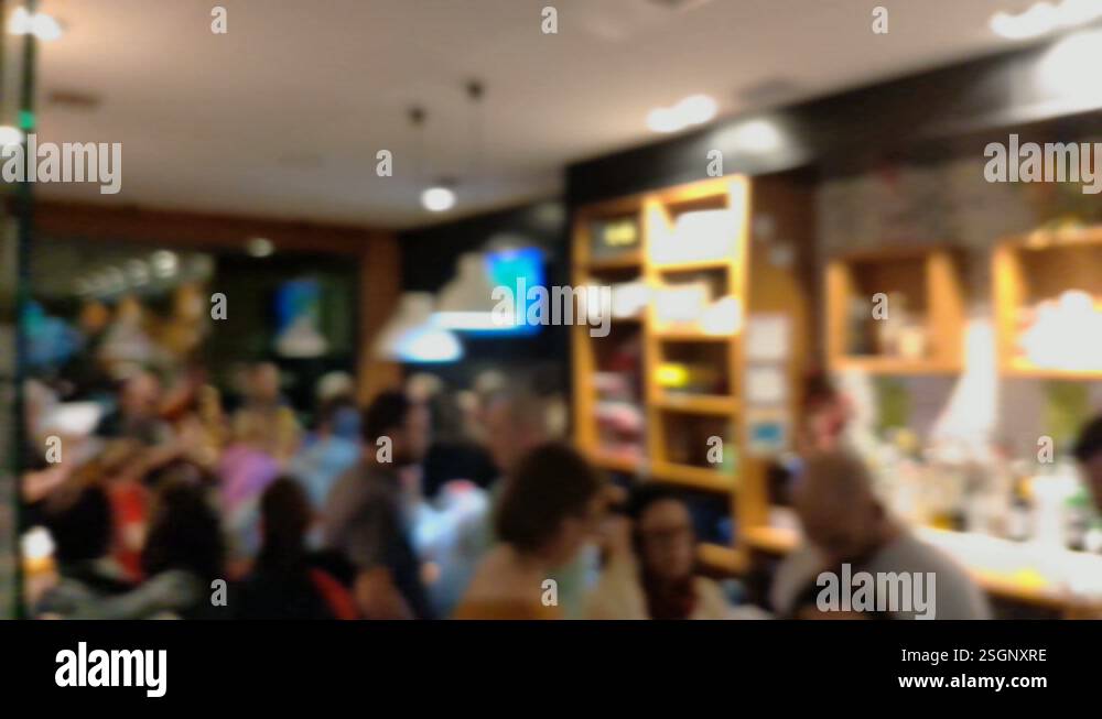 many people mingling, talking and enjoying inside a busy local cocktail ...