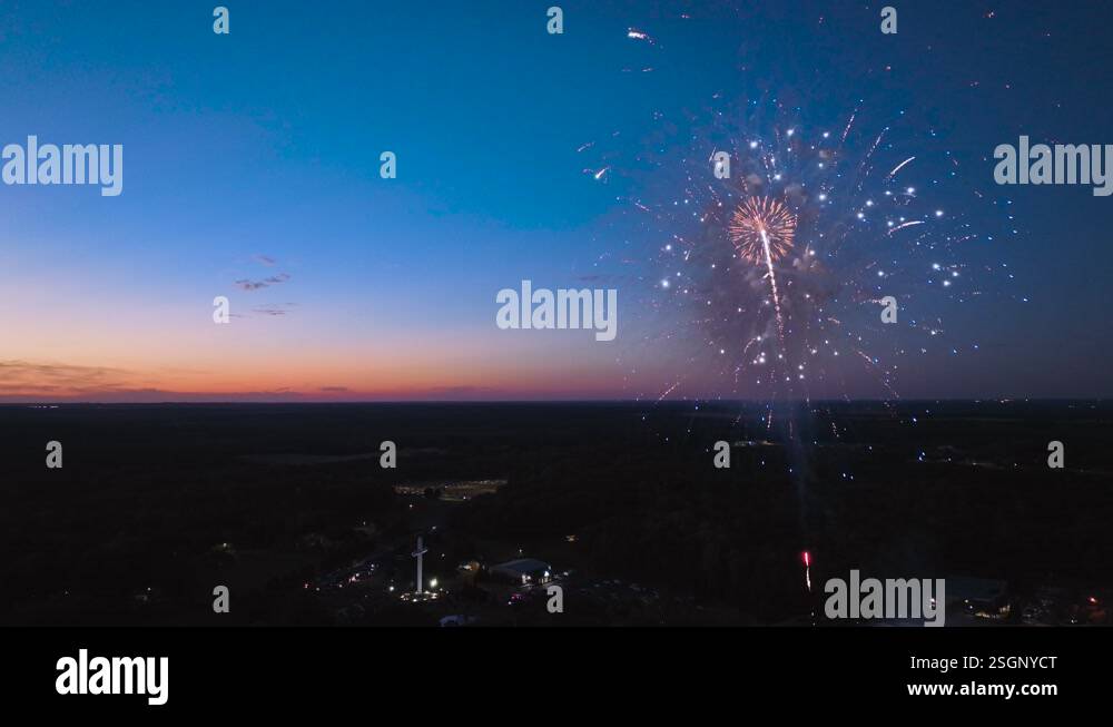 Fireworks at Twilight with cross on the background from the church ...