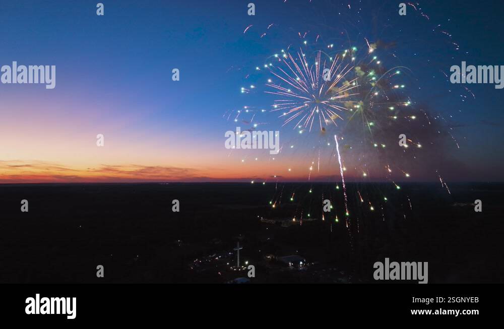Fireworks at Twilight with cross on the background from the church ...