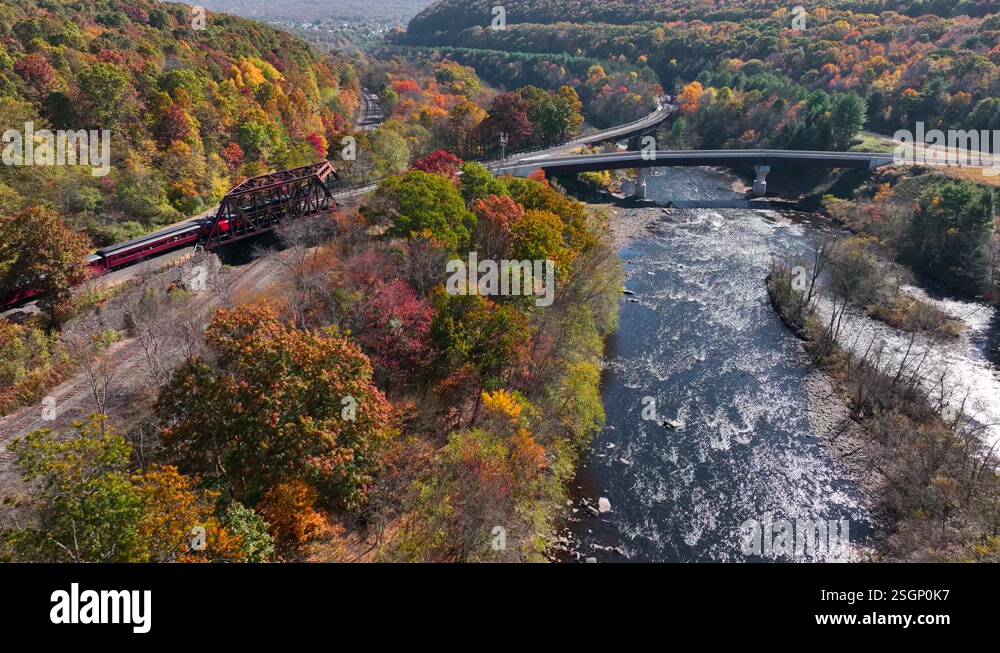 Lehigh Gorge Scenic Rail train passes over bridge. Fall autumn foliage ...