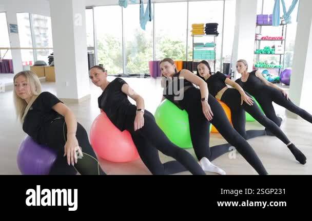 Join a lively fitness session with colorful exercise balls and dynamic ...