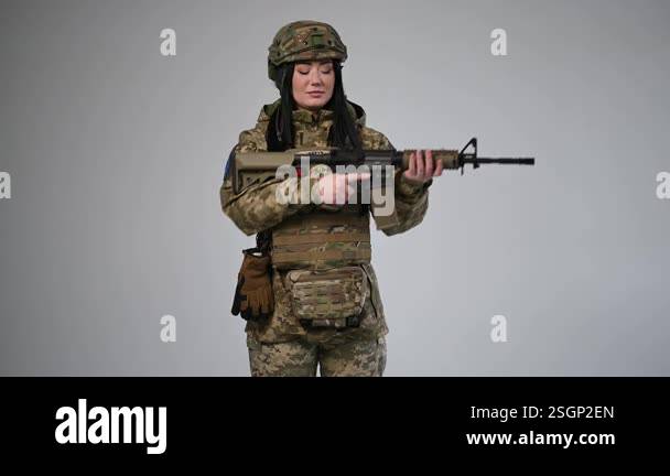 A military personnel stands confidently in their tactical gear, fully ...