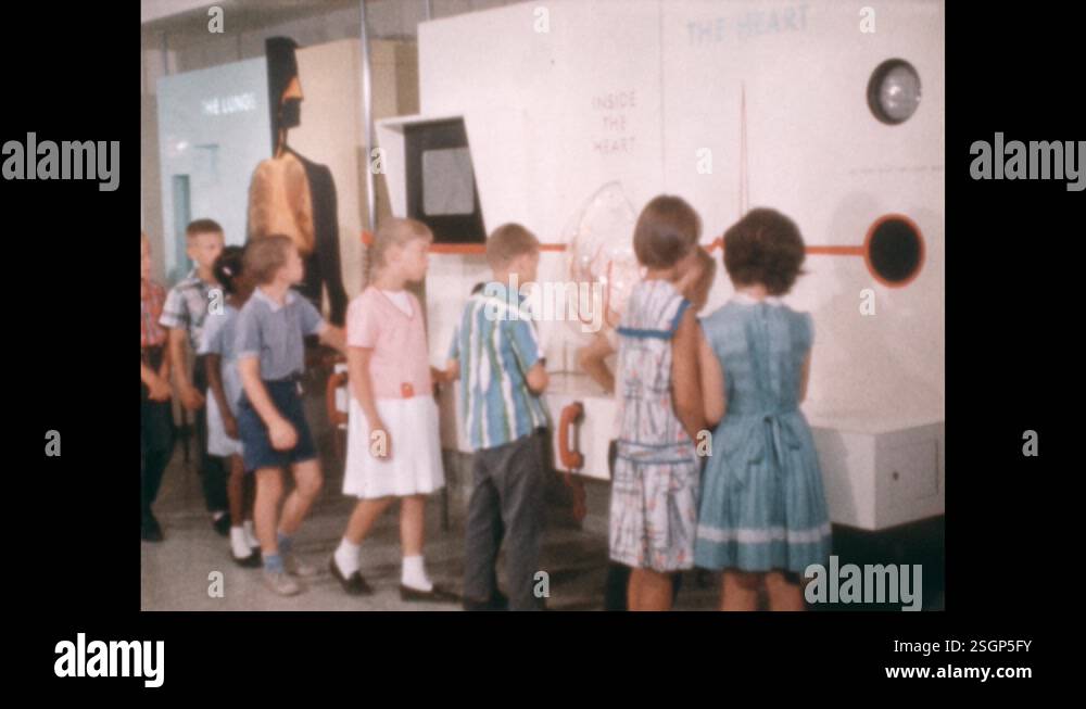 1960s: Kids looking at disply with phones. Woman opens door, kids exit ...