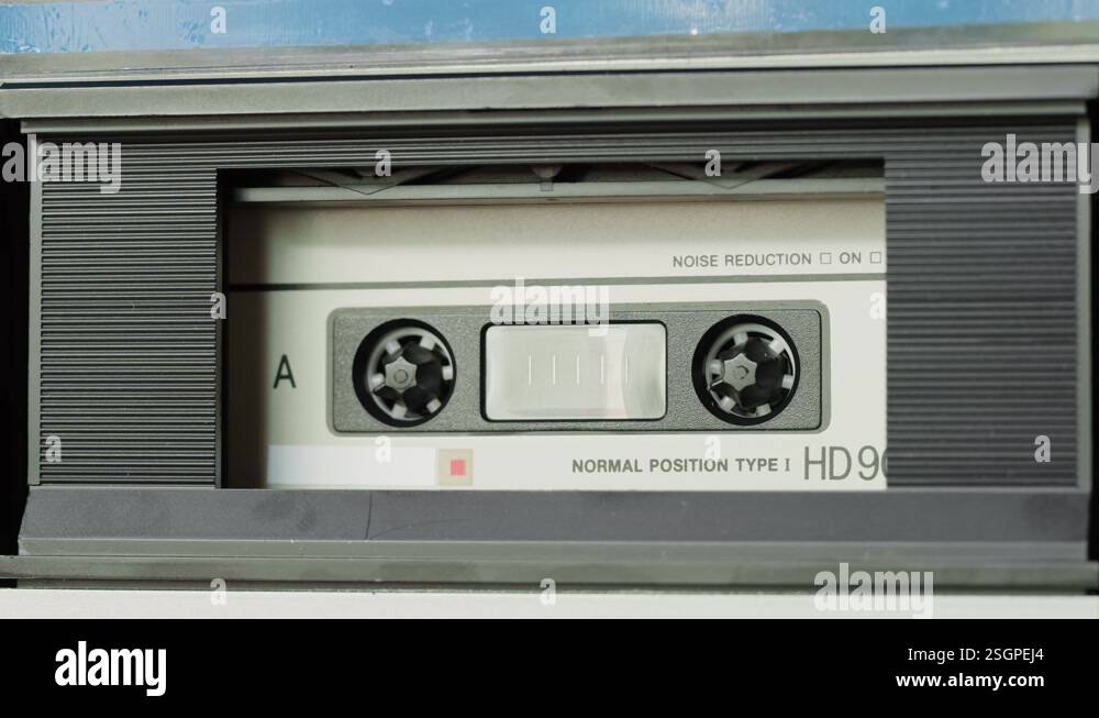 Retro radio tape recorder, audio cassette playing close-up. Listening ...