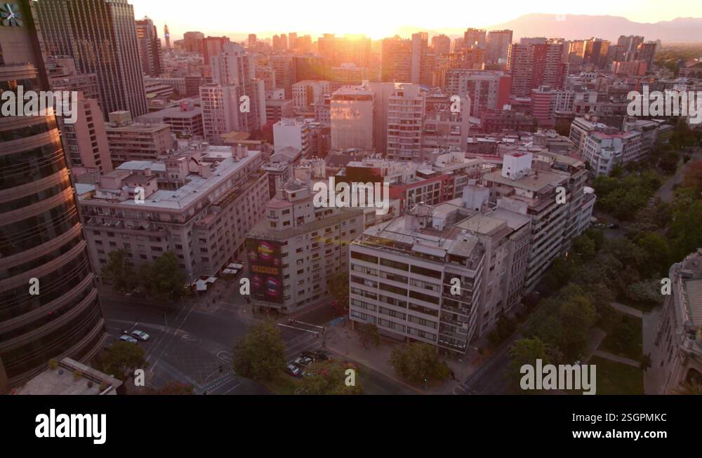 Aerial rise view of big developed downtown full of buildings at sunset ...