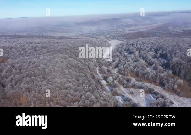 Flying over frosty winter hills and forest Stock Video Footage - Alamy