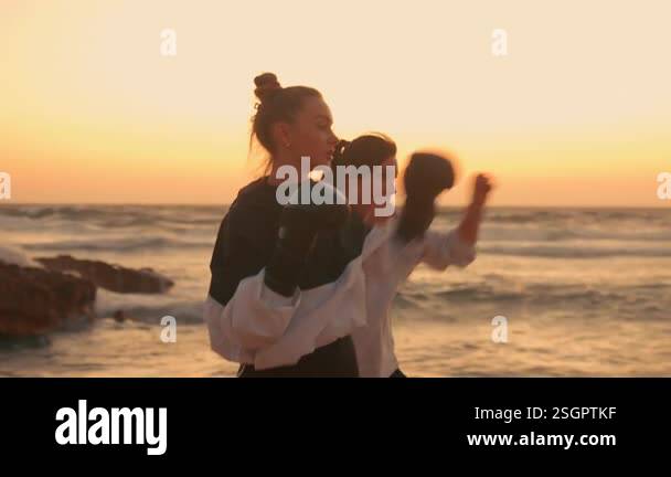 Determined sporty female fighter punching the air on the beach during ...