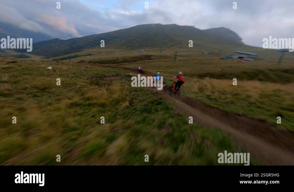 Spectacular drone flight following group of mountain biker riding ...