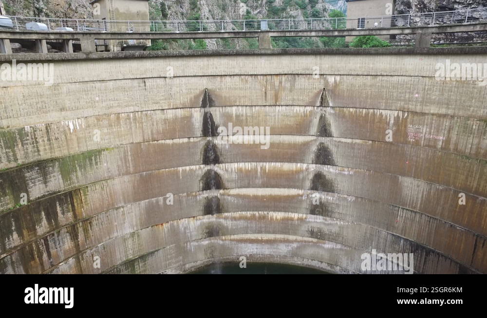 Drone shot of water flowing on the dam. view of the river channel. tilt ...