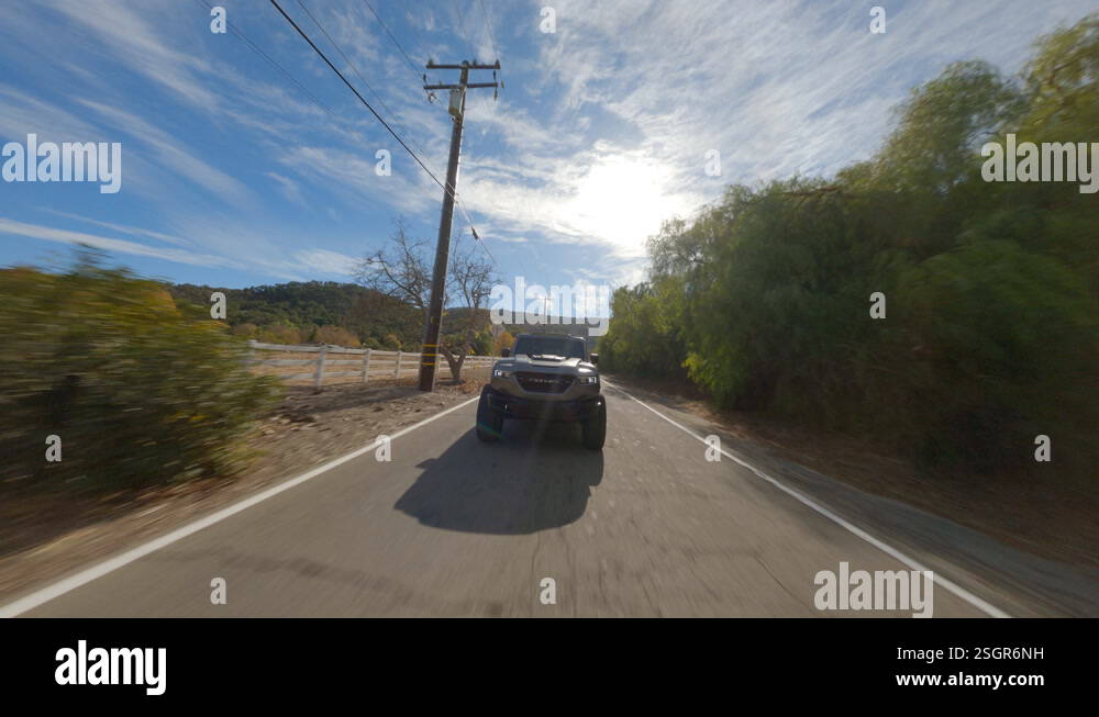 Fpv drone of black pick up driving fast on road. Four wheel car, front ...