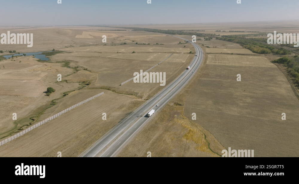 One Semi Truck with trailer driving, traveling alone on straight empty ...