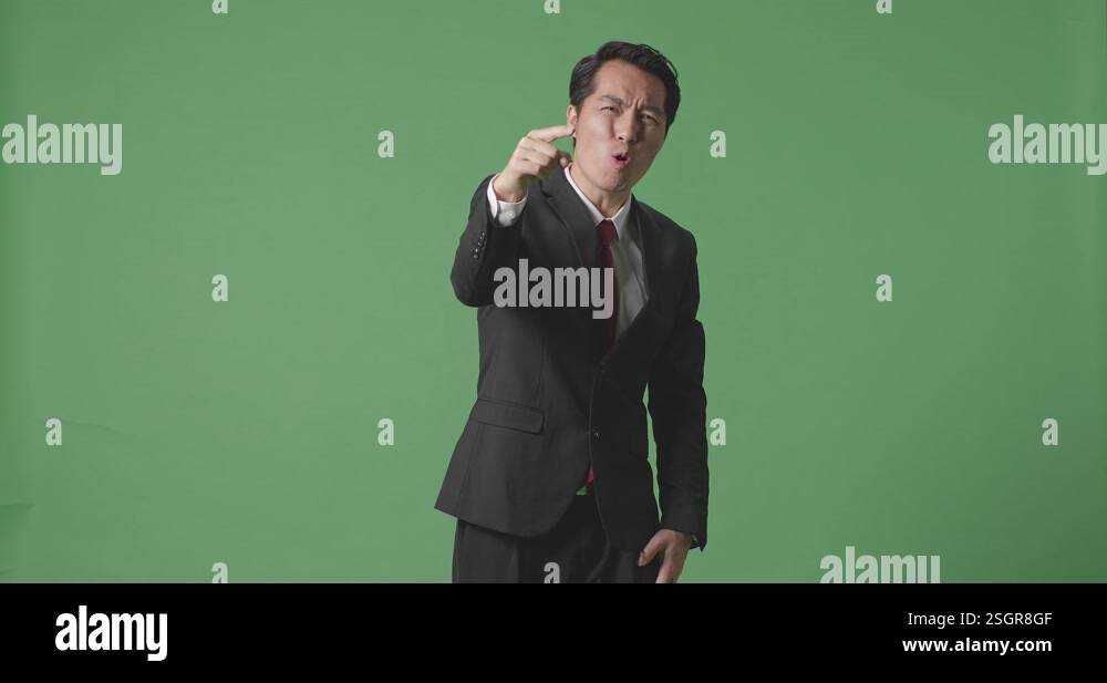 An Angry Asian Business Man Scolding While Standing On Green Screen ...