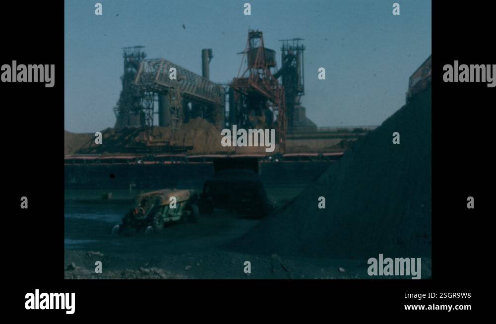 1950s: Woman packing box on the assembly line. Loaders putting coal on ...