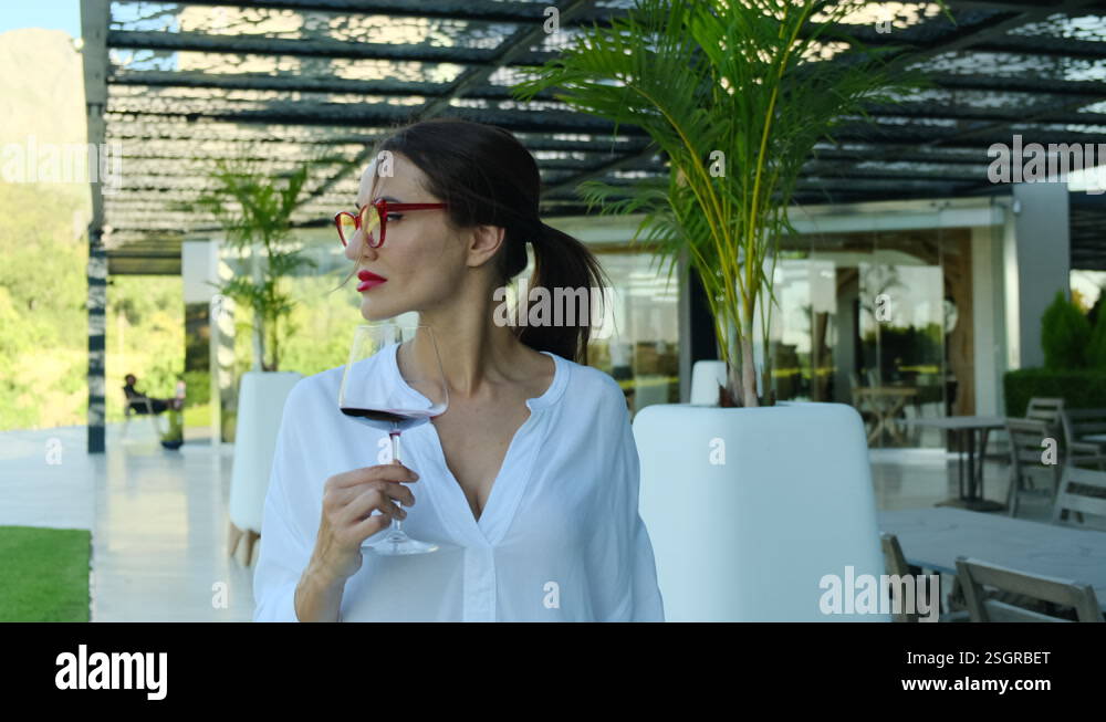 successful confident woman in glasses and red lipstick drinking white ...