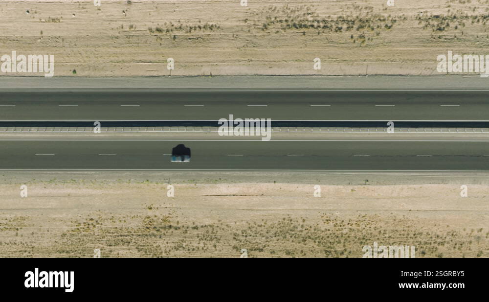 One gray sedan car driving alone, travel on empty straight asphalt road ...