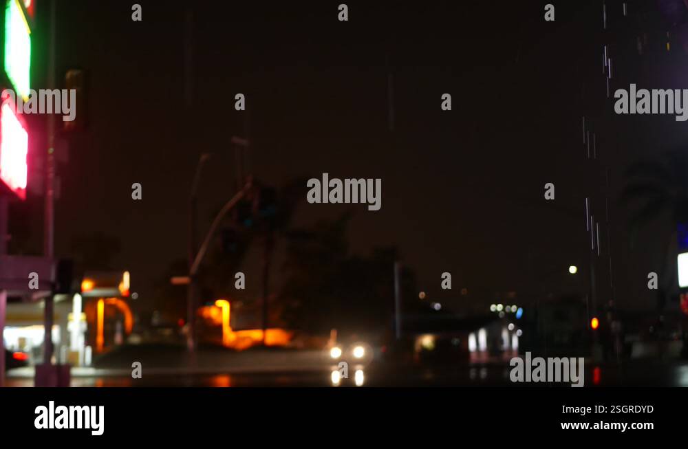 Rain drops drip from roof. Rainwater trickle at night. Rainfall on city ...