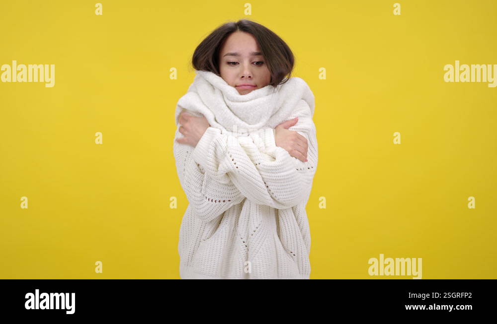 Brunette woman shivers from cold and breathes on palms Stock Video ...