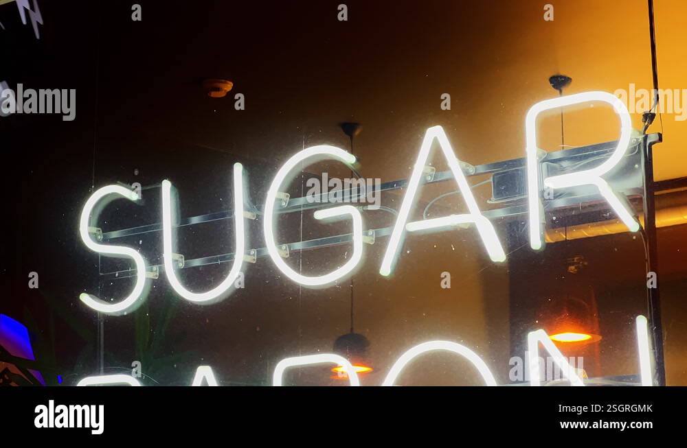 Neon Sugar sign at a cafe or bar at night Stock Video Footage - Alamy