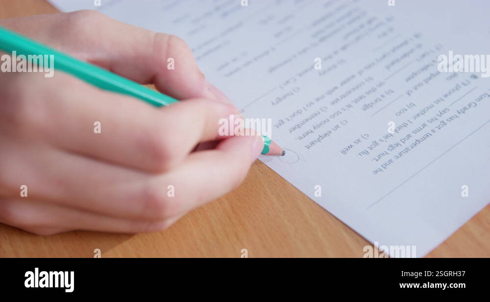 Teacher hand checks test and draws on paper with pencil Stock Video ...