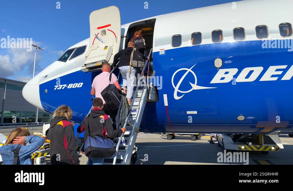 People boarding and going up the stairs on a big Ryanair boeing ...