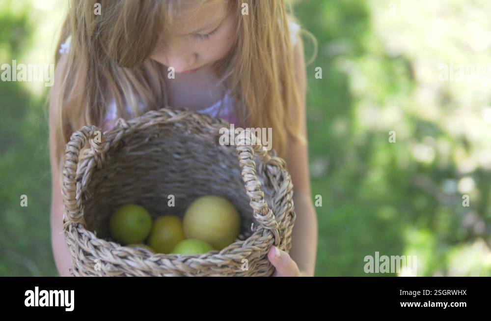 A sad little girl with a basket of green lemons Stock Video Footage - Alamy