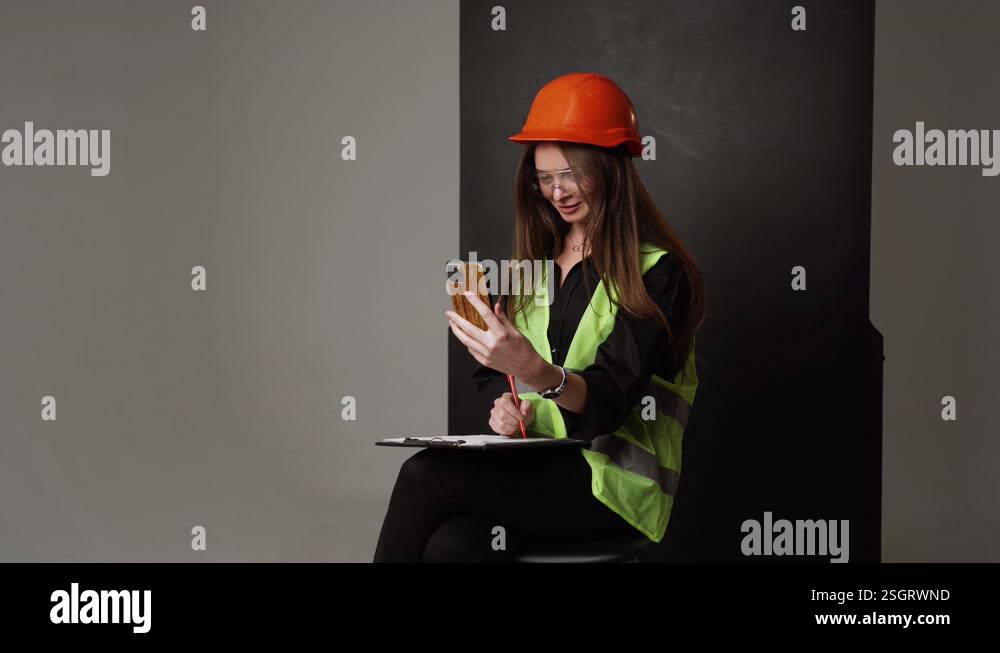 Woman engineer dressed in overalls communicates via video link Stock ...