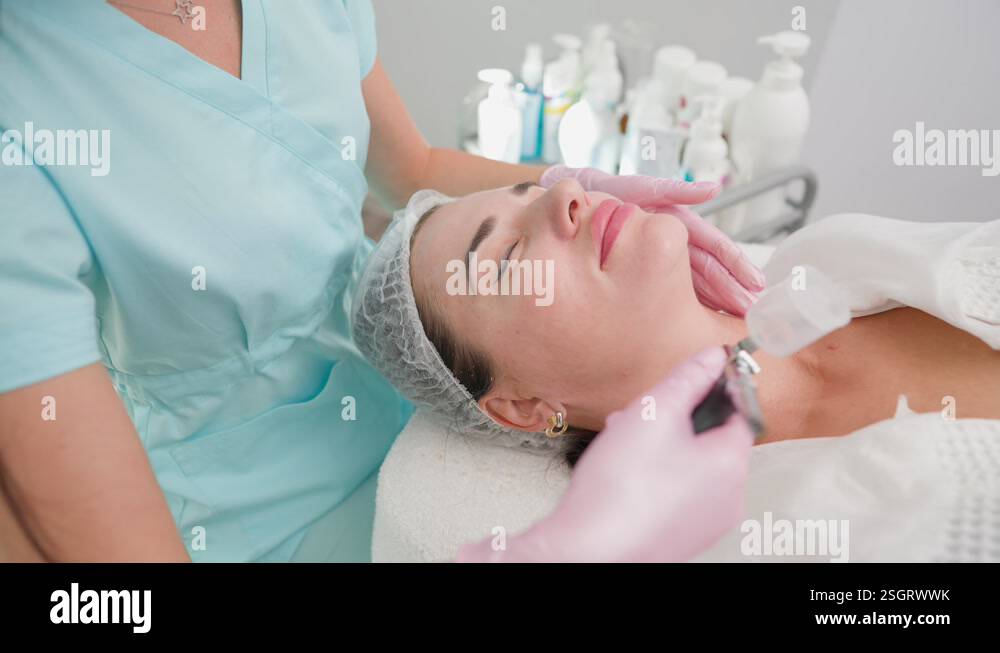 Woman Beautician Makes Rejuvenating Facial Skin Procedure of a Female ...