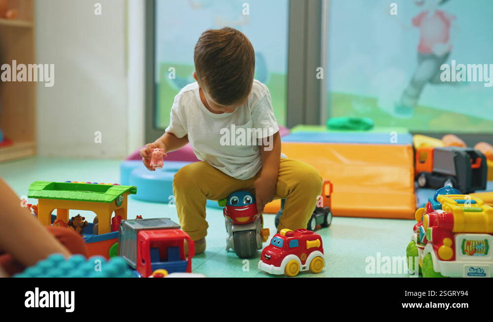 floor full of toys and kids playing with them, preschoolers having fun ...