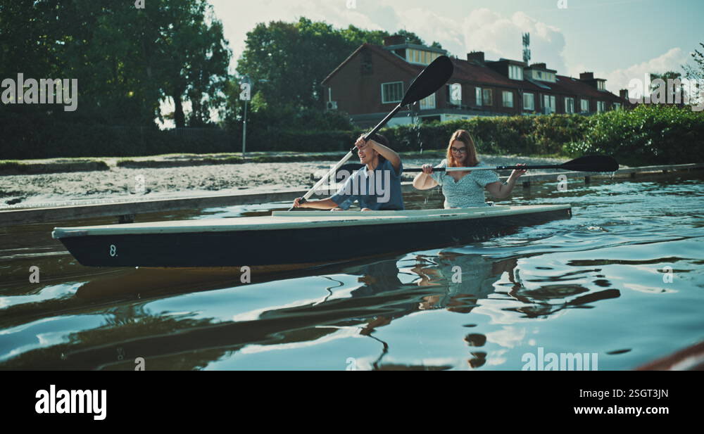Girlfriends paddling in white canoe side view Stock Video Footage - Alamy