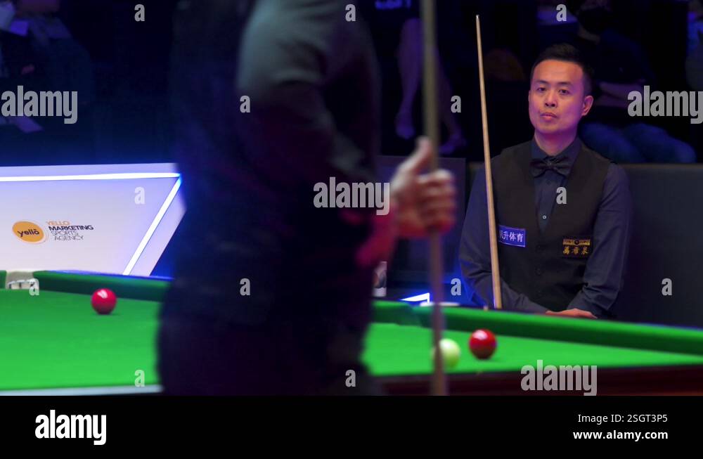 Snooker player of Hong Kong, Marco Fu, looks on as World Champion and ...