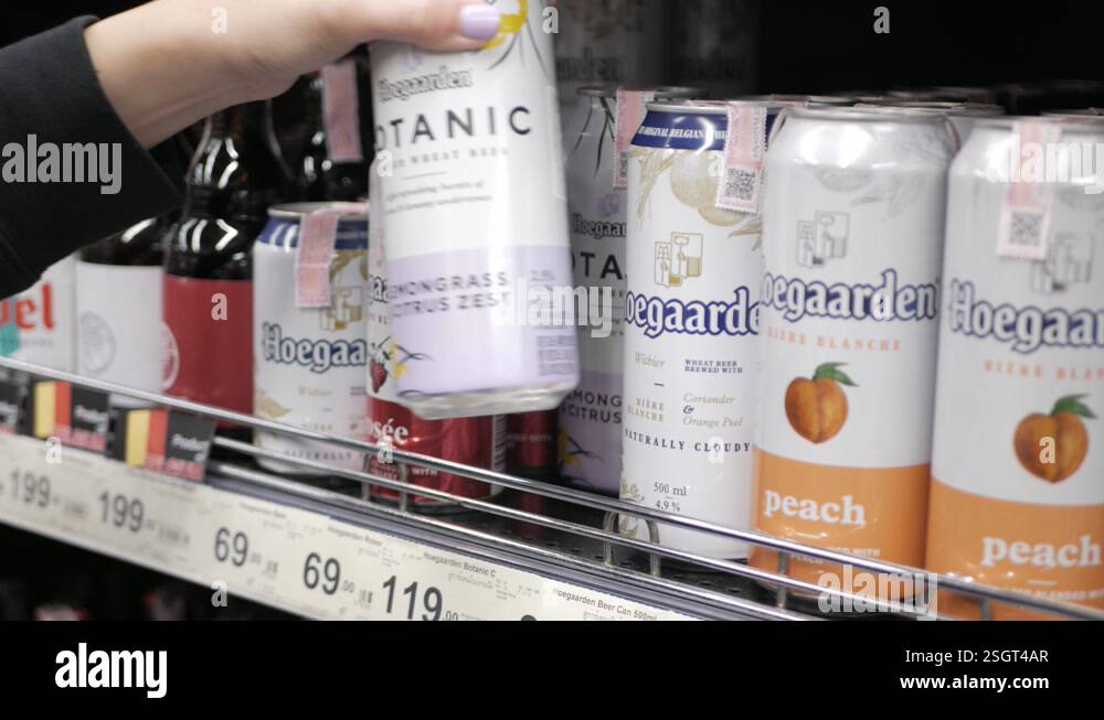 grab hoegaarden alcohol beer from the beverage shelf in supermarket ...
