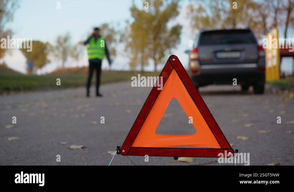 Warning triangle on road, broken car, malfunction, driver calling for ...