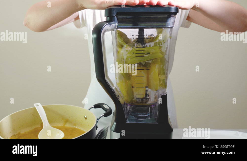 Celery soup step by step recipe. Placing boiled vegetables into a ...