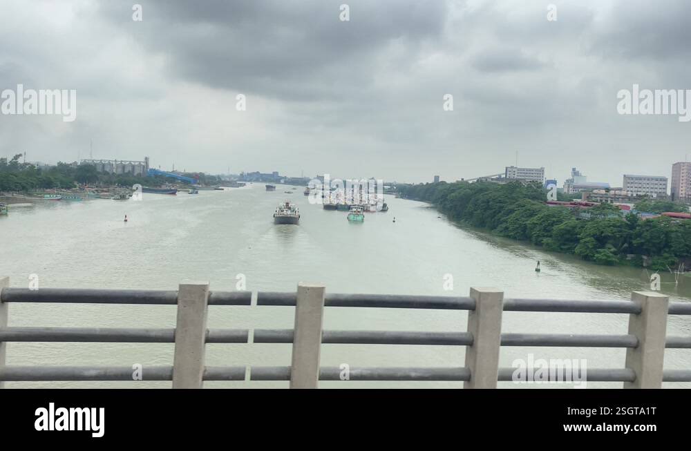 Driving on bridge in Sylhet over Surma river with port in distance ...