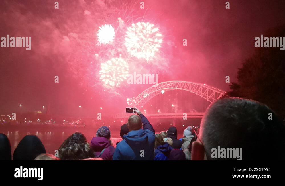 People watch colourful fireworks exploding on Silver Jubilee bridge ...