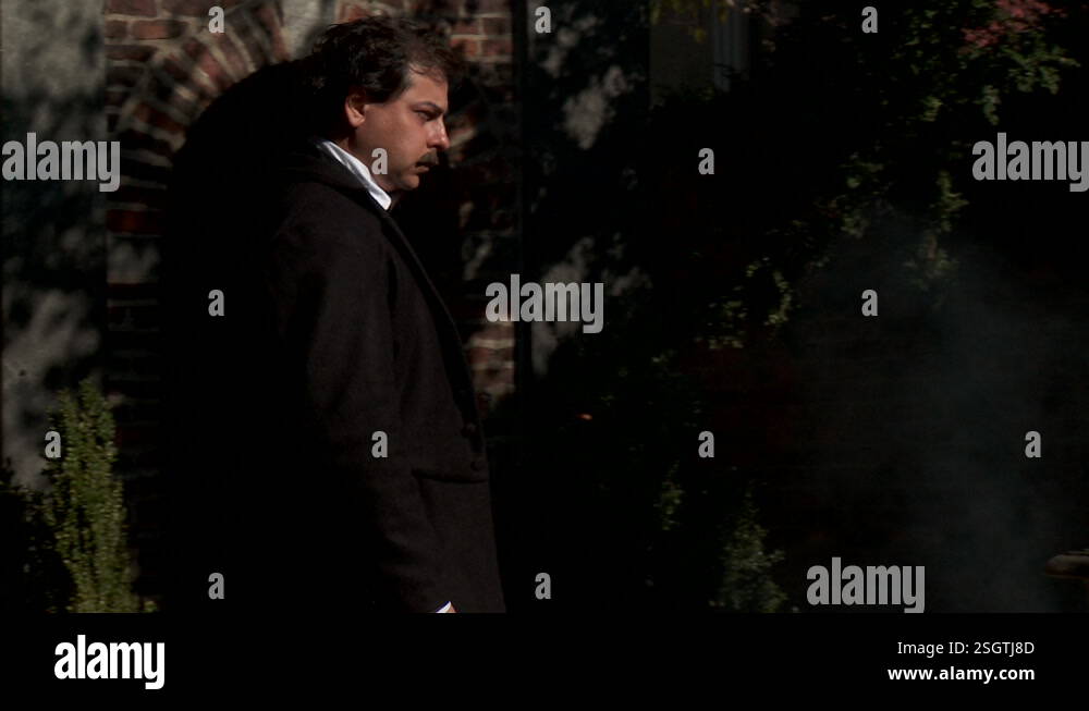 Author Edgar Allen Poe stands pensive in a glooomy Garden - Actor ...