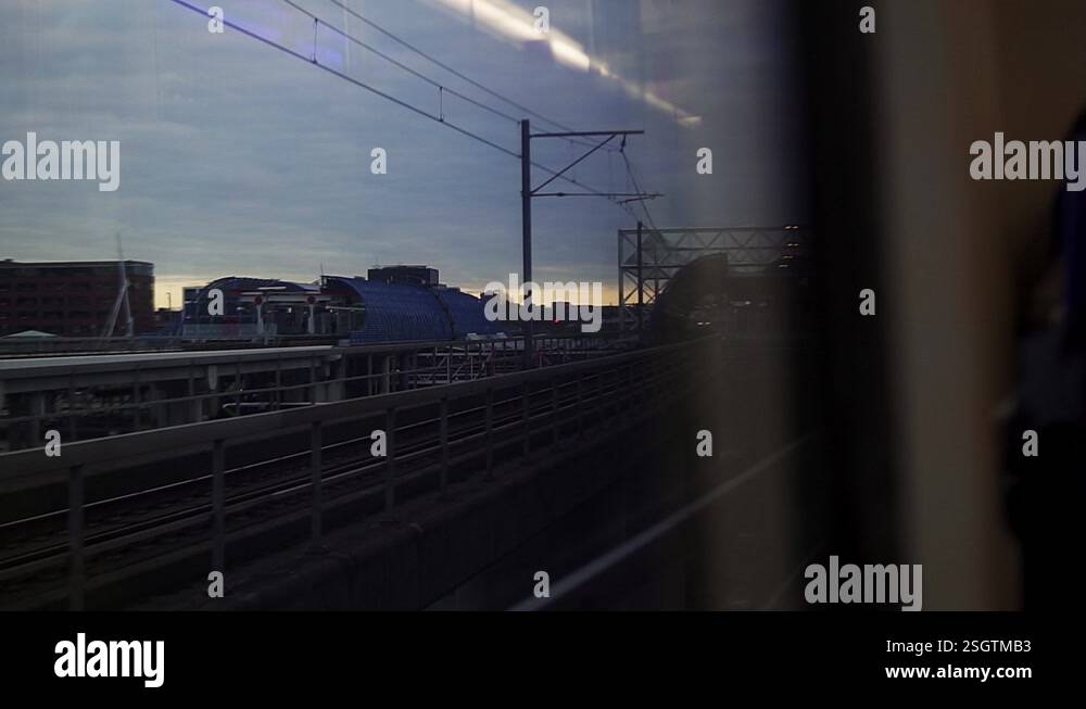 Train passenger point of view through window over railroad tracks and ...