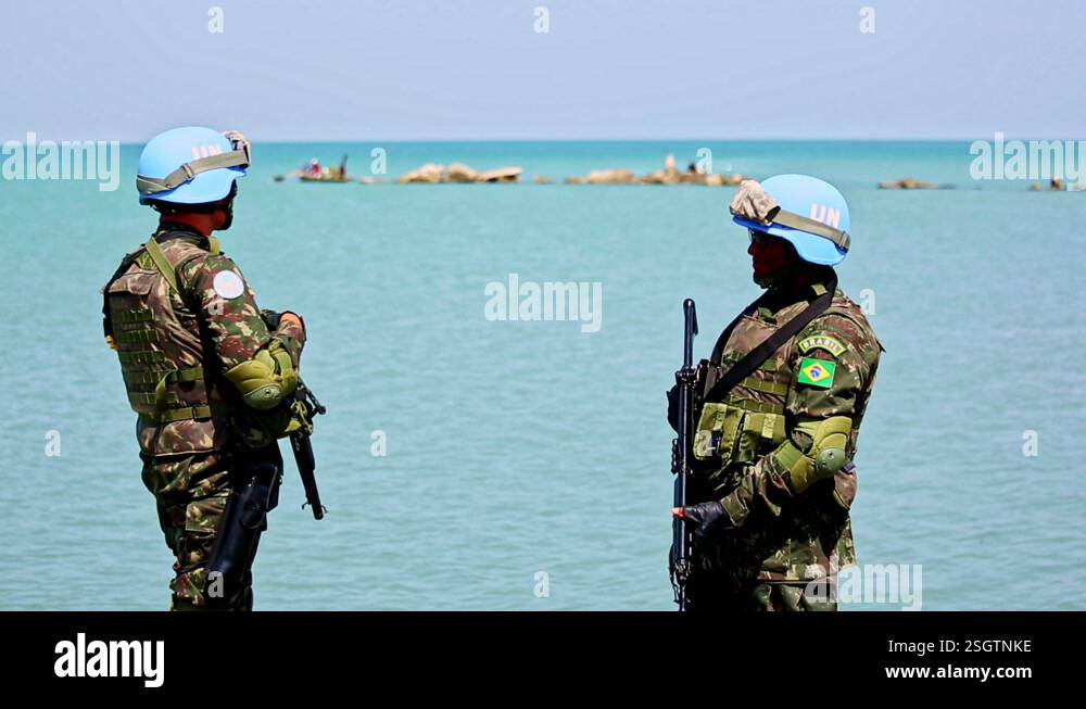 Two armed UN soldiers from Brasil talking during peace keeping mission ...