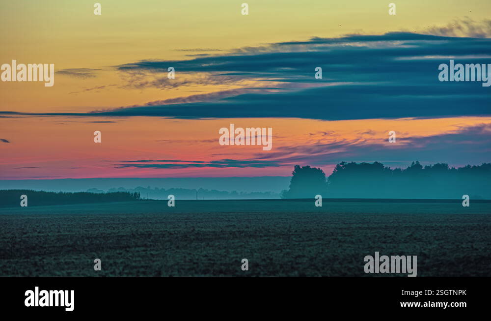 Time lapse shot of flying clouds at sky during colorful morning sunrise ...