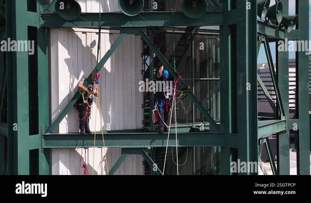 People pulling the US flag up to a tower on Independence day in USA ...