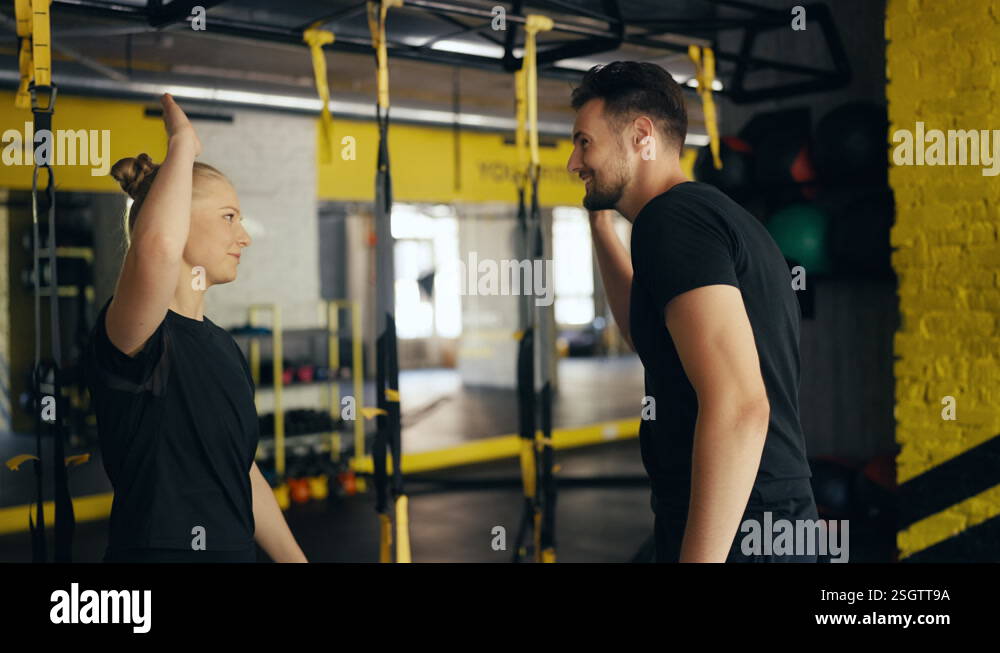 Fitness coach and young man giving each other high five after workout ...