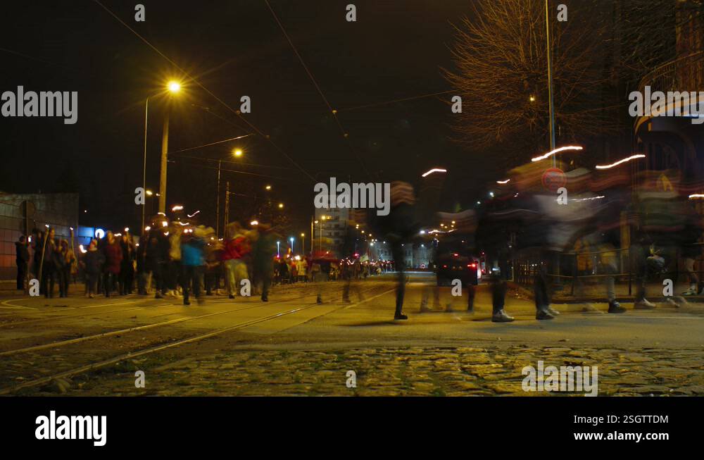 Timelapse of people going in a torchlight procession over the Liepaja ...