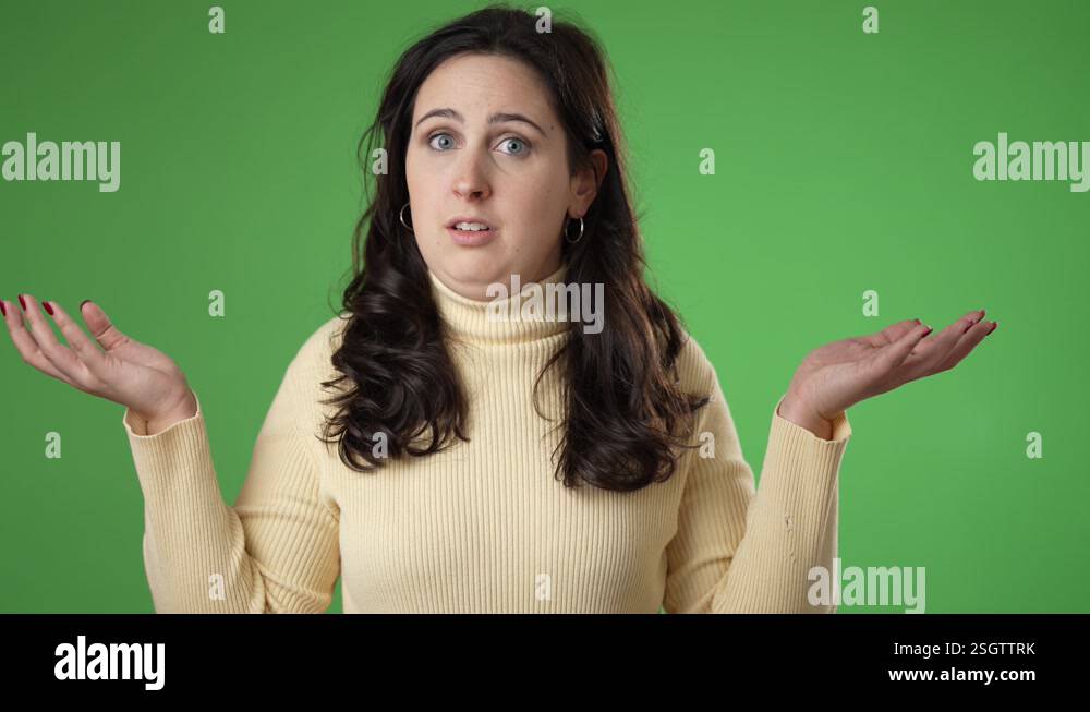 Portrait of happy pretty woman 20s shrugging shoulders and gesturing I ...