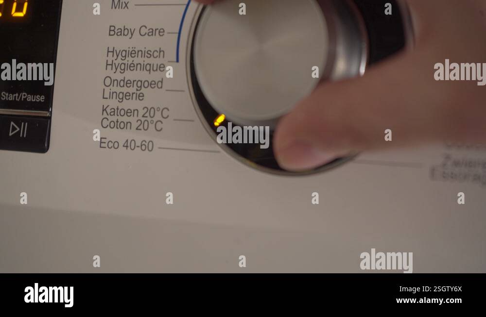 Narrow focus close-up: Dutch laundry washer dial turned to eco setting ...