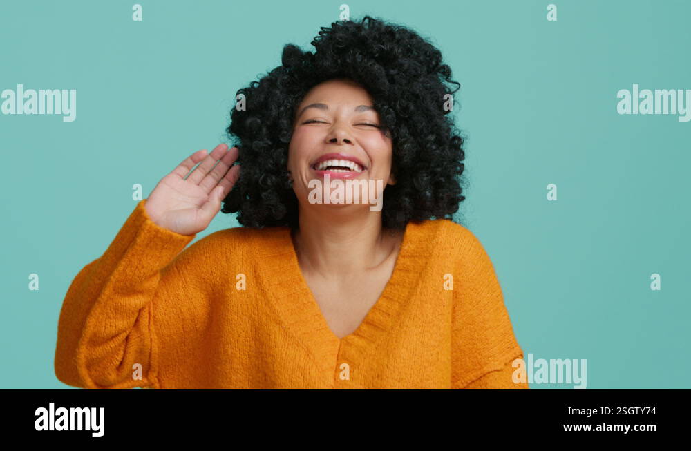 Playful African American model joking by showing hand at head gesture ...