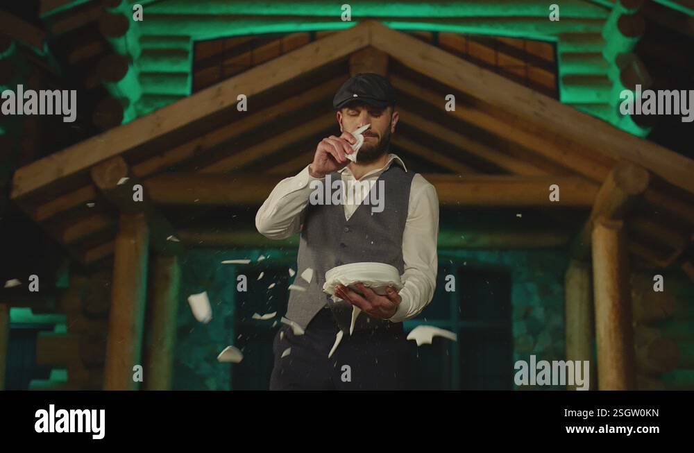 Young man breaking and smashing many plates in his hand. Greek ...