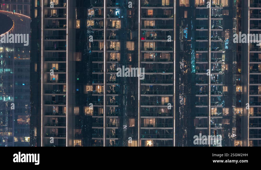 Windows in high-rise building exterior in the late evening with ...