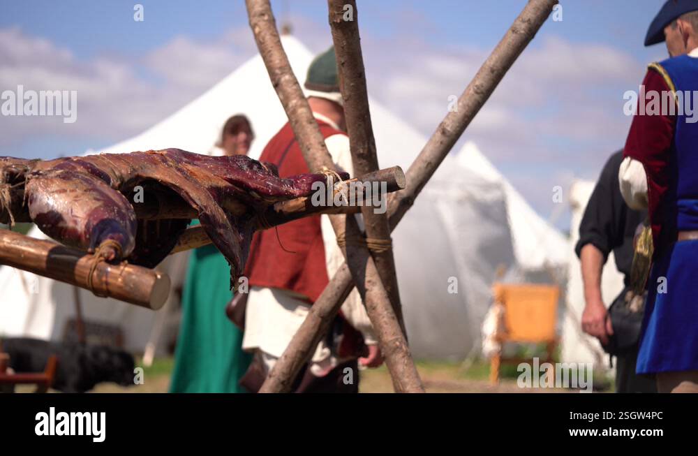 Roasting Meat At Medieval Camp With Actors In Costumes And Tents In ...